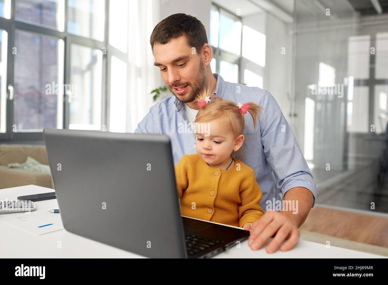 working father with baby daughter at home office Stock Photo - Alamy