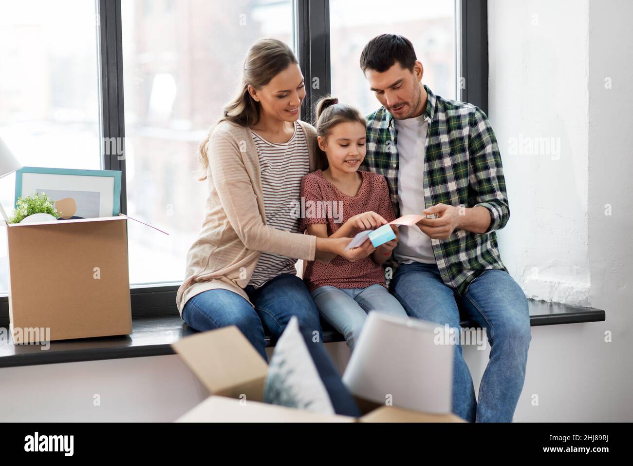 happy family with color palette moving to new home Stock Photo - Alamy