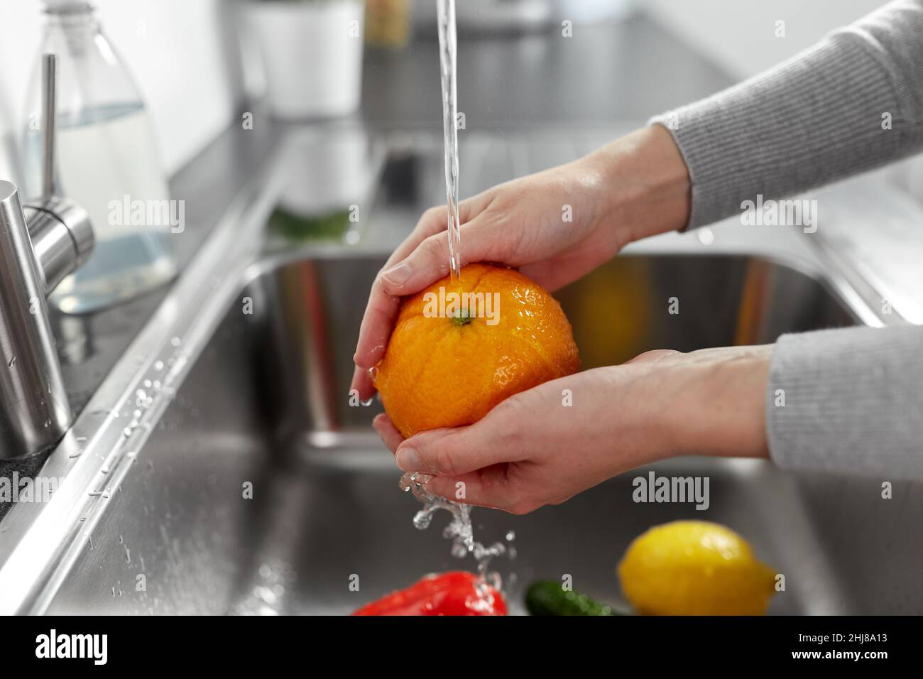 woman washing fruits and vegetables in kitchen Stock Photo - Alamy