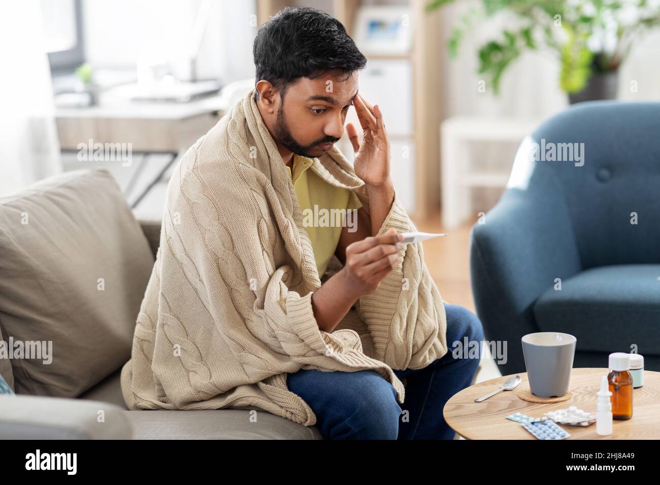 sick man measuring temperature by thermometer Stock Photo - Alamy