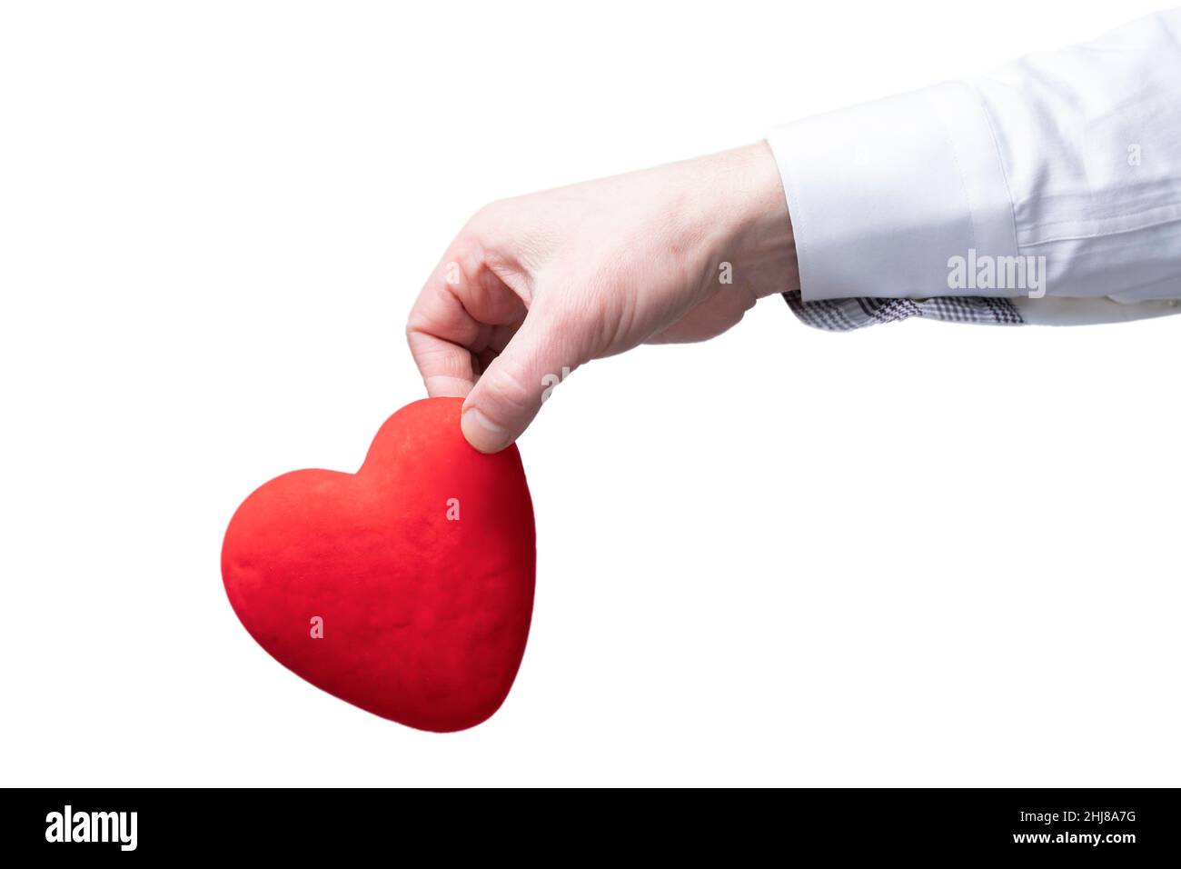 a man's hand holds a red heart on a white isolate background. throws ...