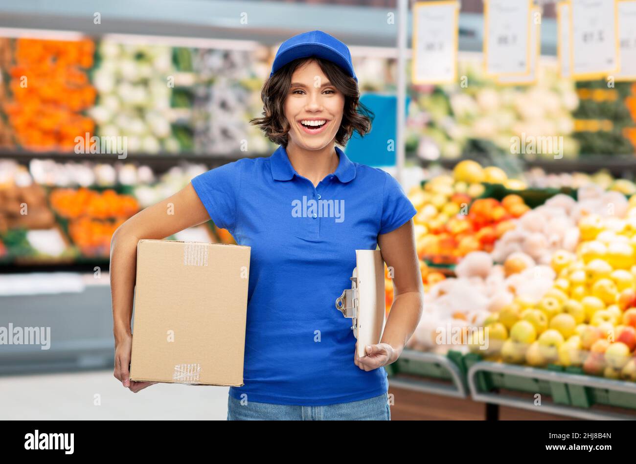 happy delivery girl with box at grocery store Stock Photo - Alamy