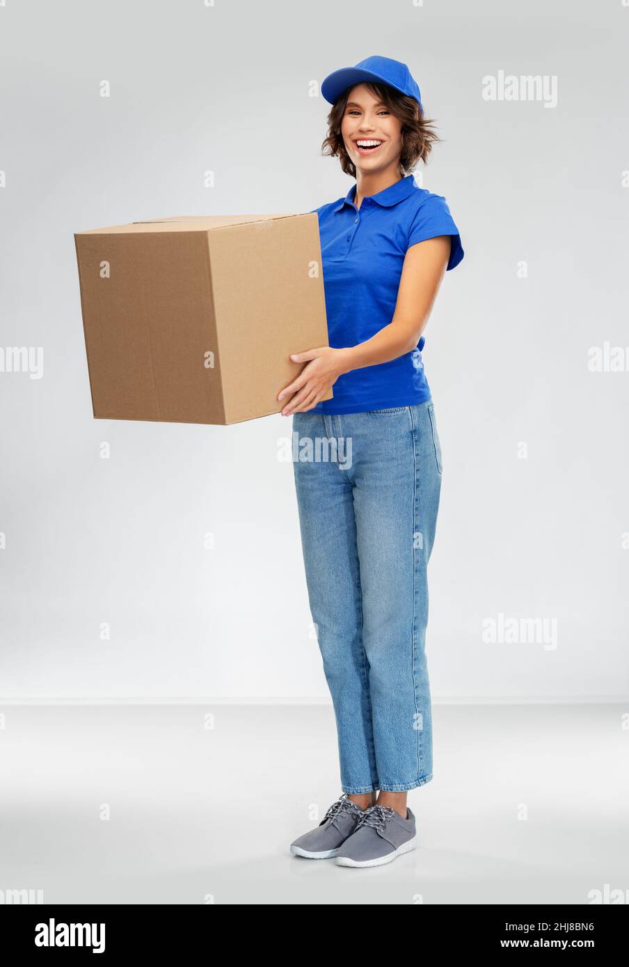 happy smiling delivery woman with parcel box Stock Photo - Alamy