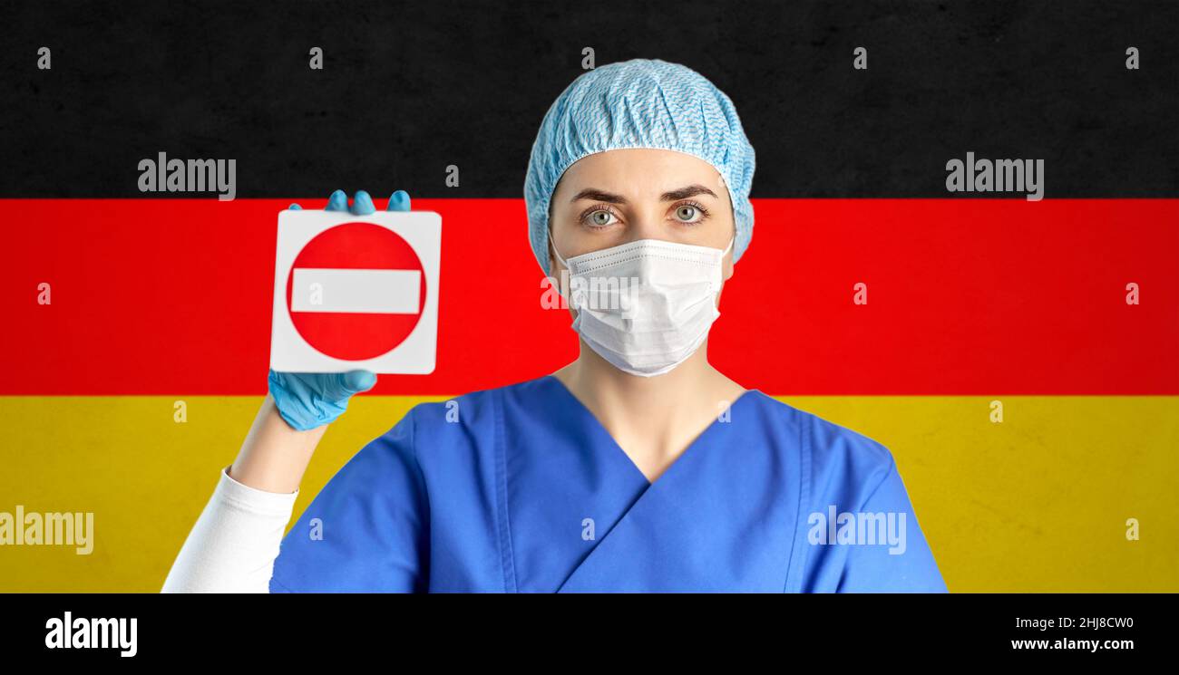 german doctor or nurse in mask showing stop sign Stock Photo - Alamy