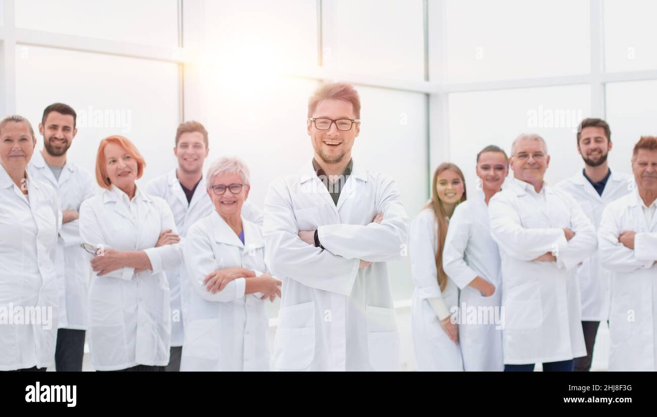 confident scientific leader standing in front of a team of young ...