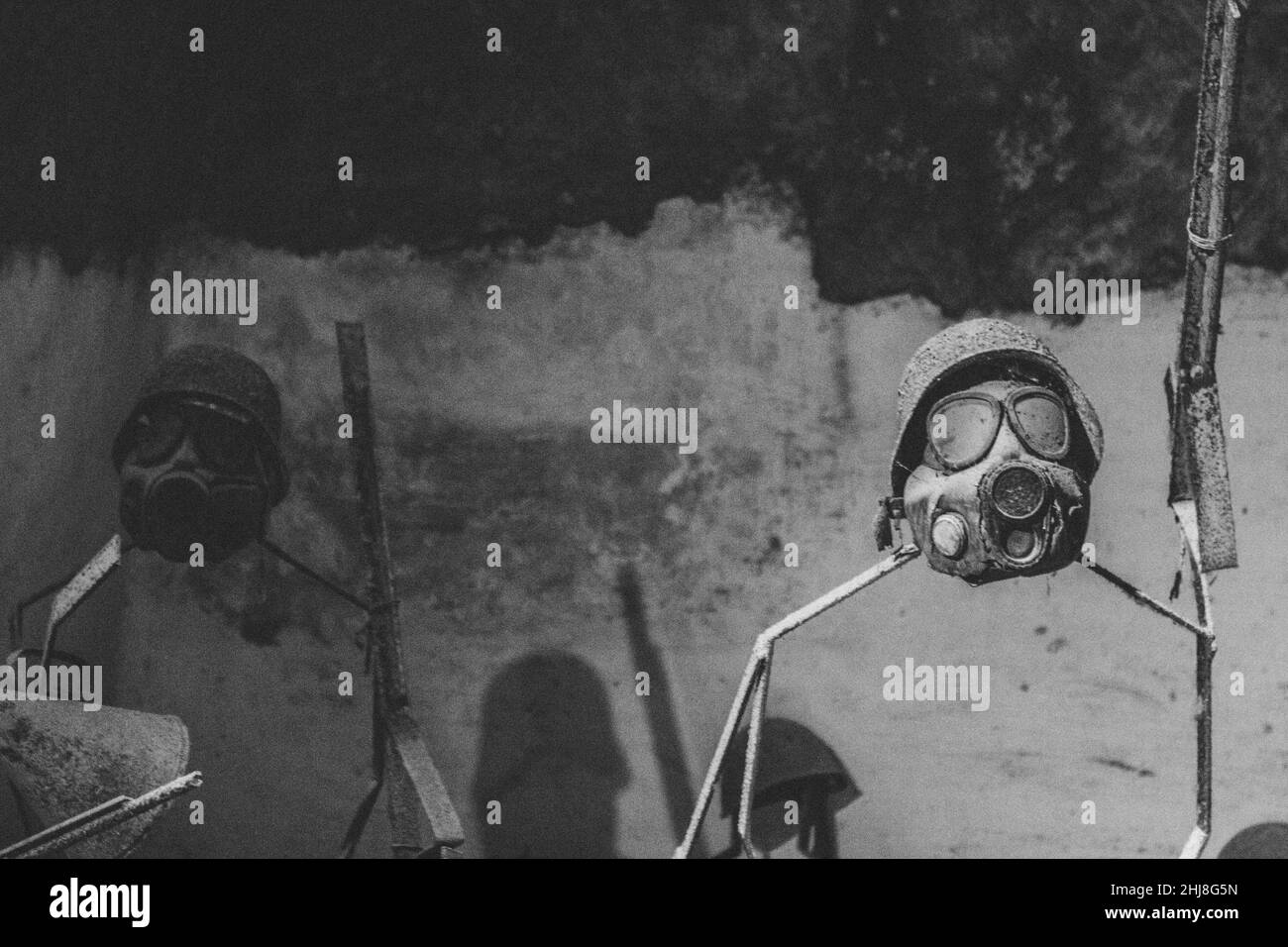 Disturbing image of two wartime gas masks put on two sticks shot in ...