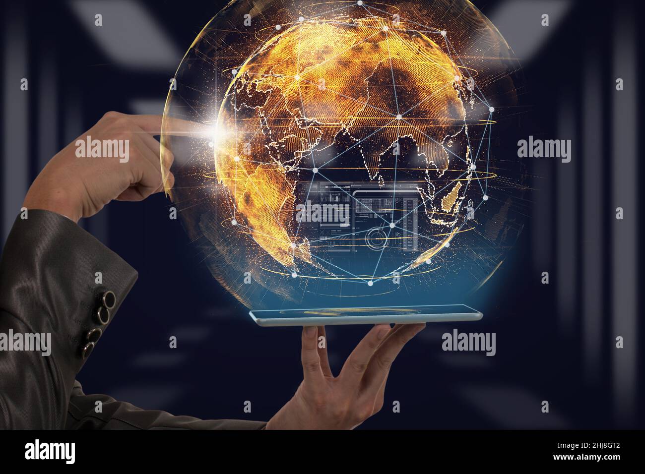 Hand holding the lablet and pointing the particle of earth over the ...