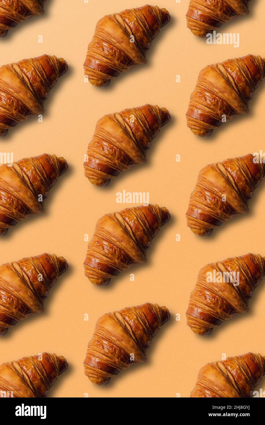 Vertical croissant pattern with orange background and copy space Stock ...