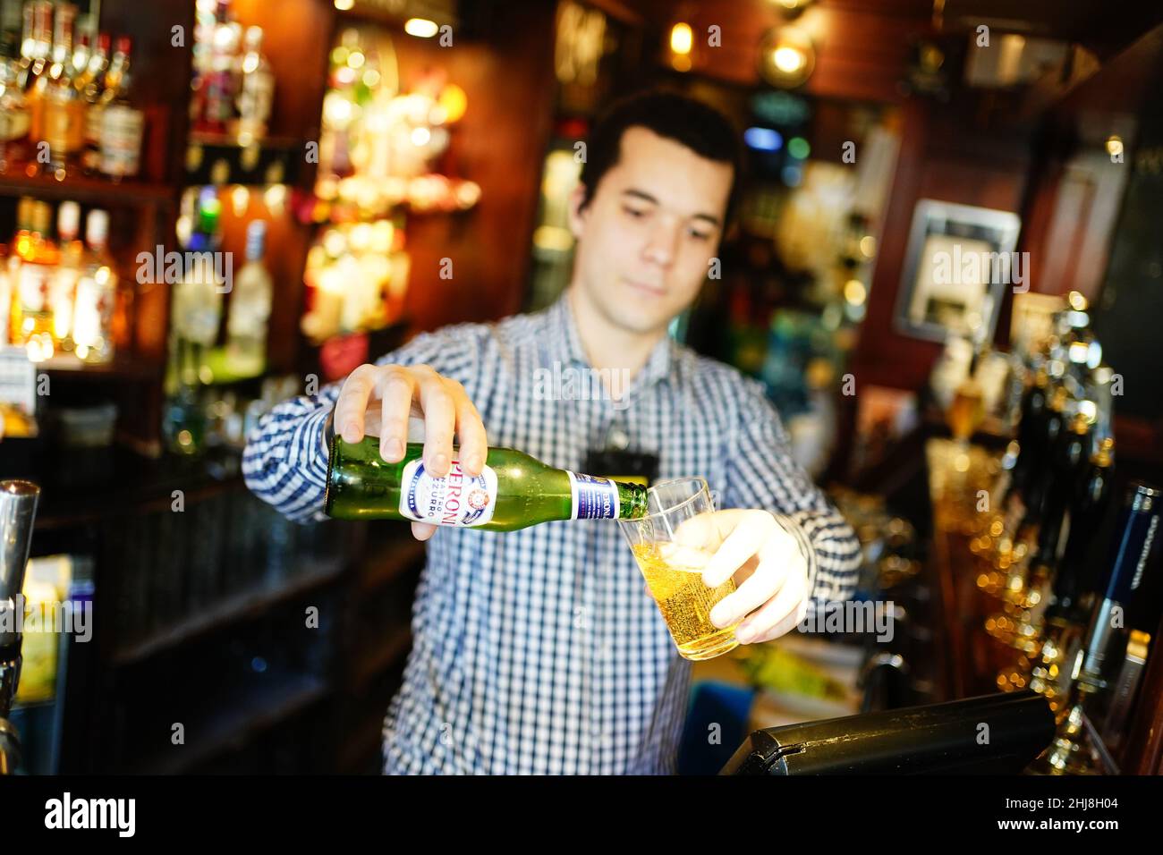 Pub manager Calvin Mitchell holds a half pint of Peroni which was the ...