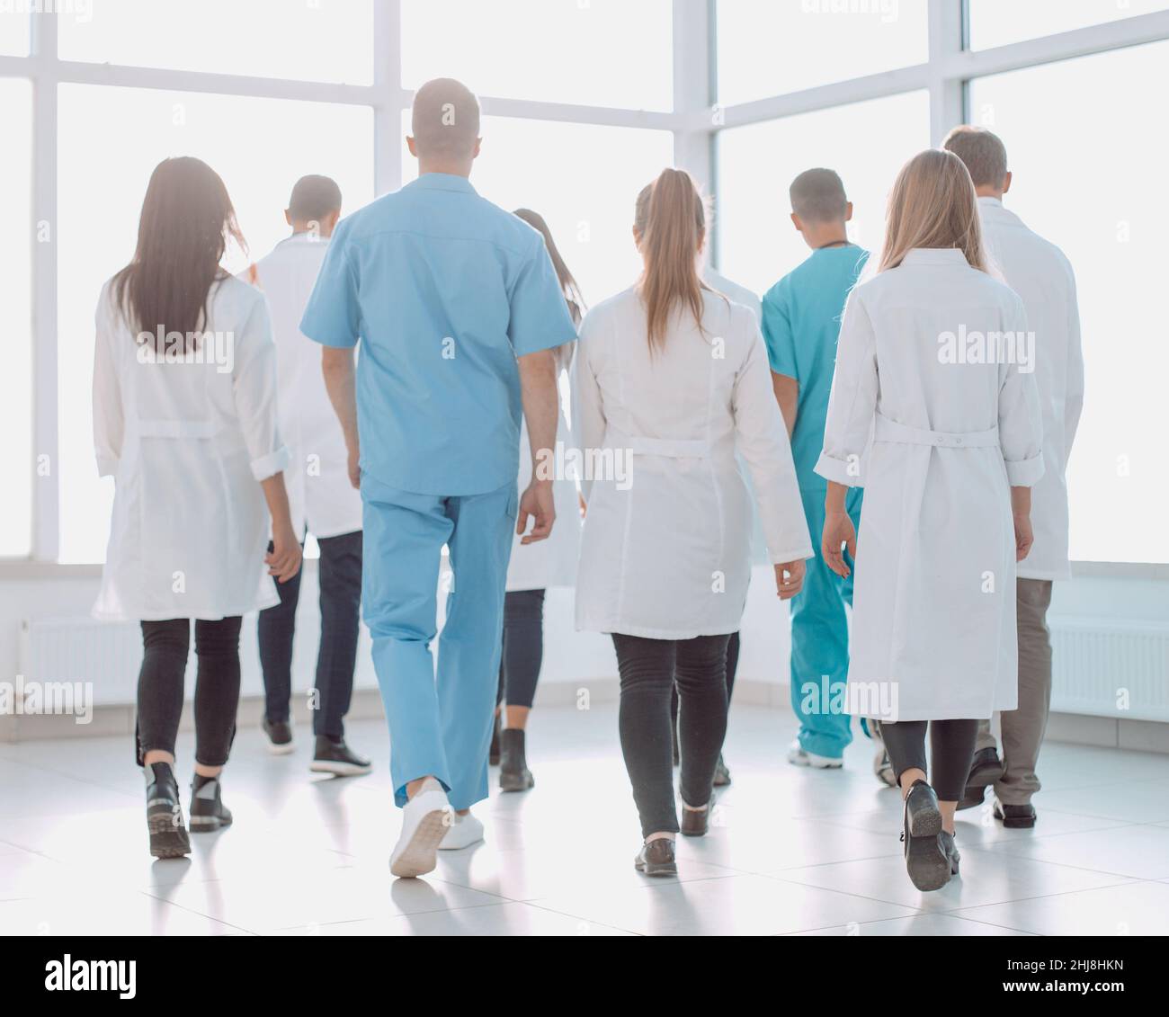 rear view. doctors of the medical center walking in the corridor Stock ...