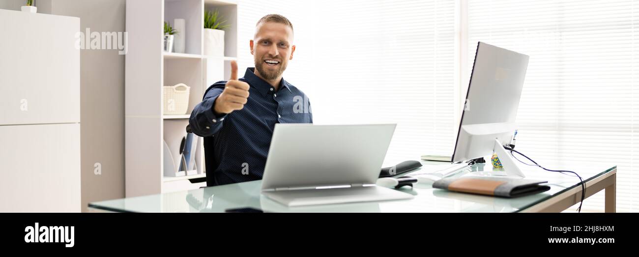 Happy young businessman using laptop hi-res stock photography and ...