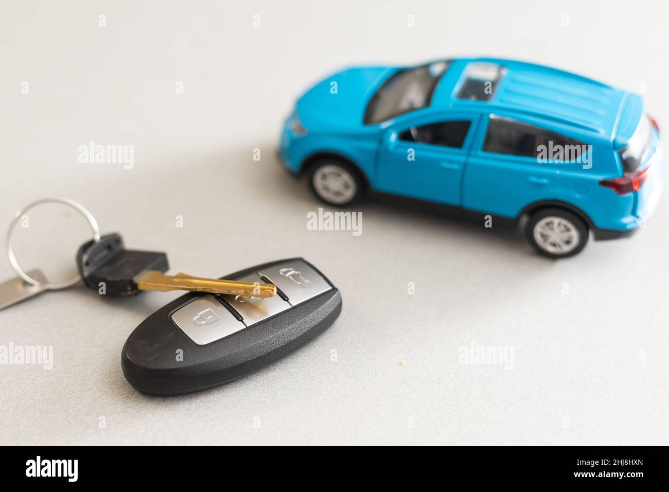 Toy car and keys car on white background Stock Photo - Alamy