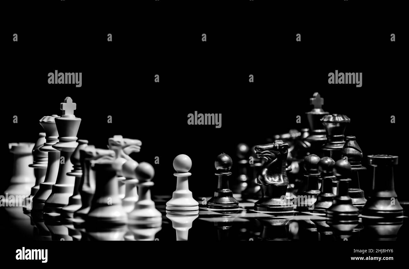 Close up of Chess pieces on a reflective mirror board surface with a ...