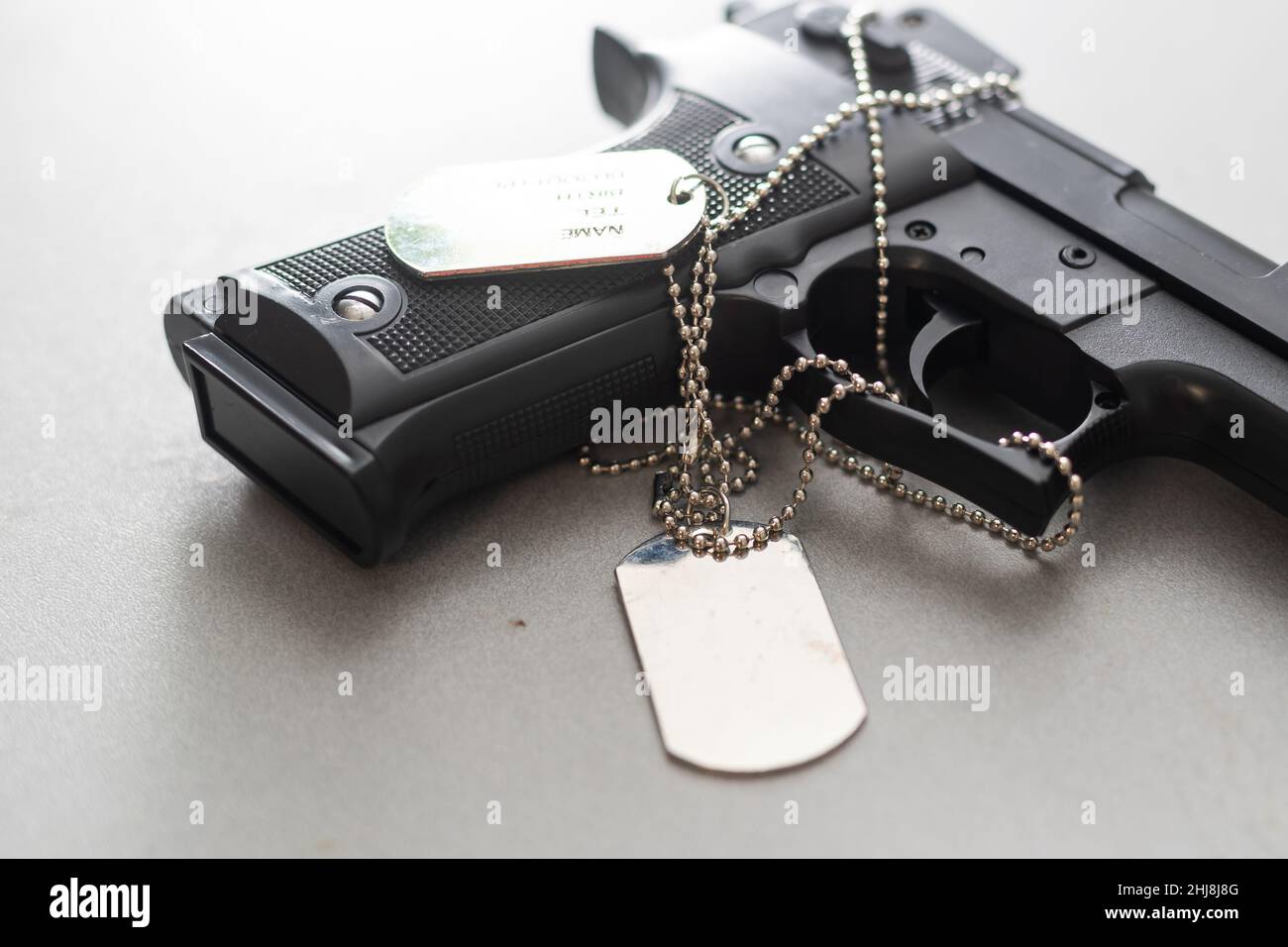 gun and dogtag isolated on a white background Stock Photo - Alamy