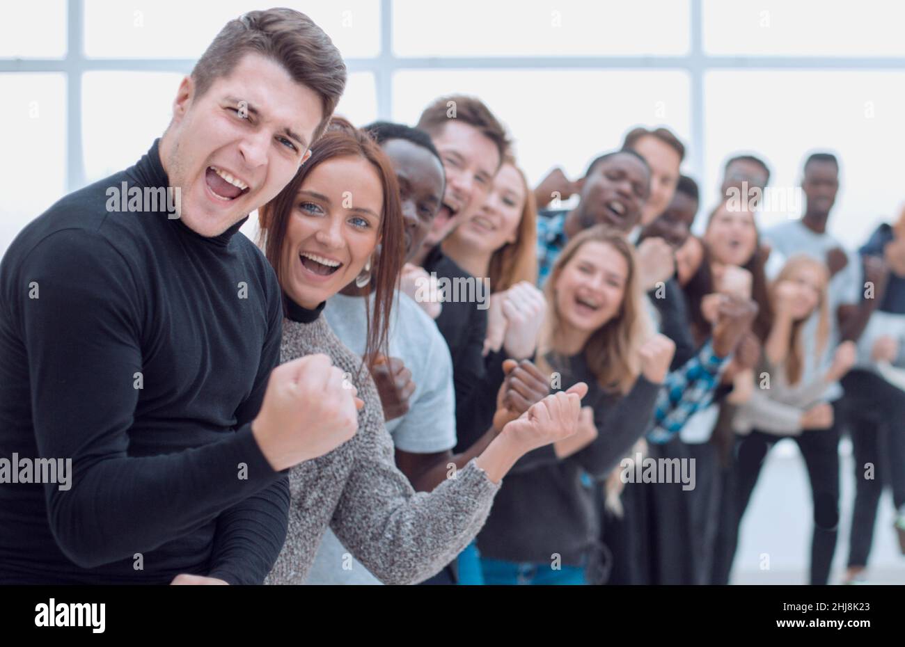 group of happy young people standing behind each other Stock Photo - Alamy