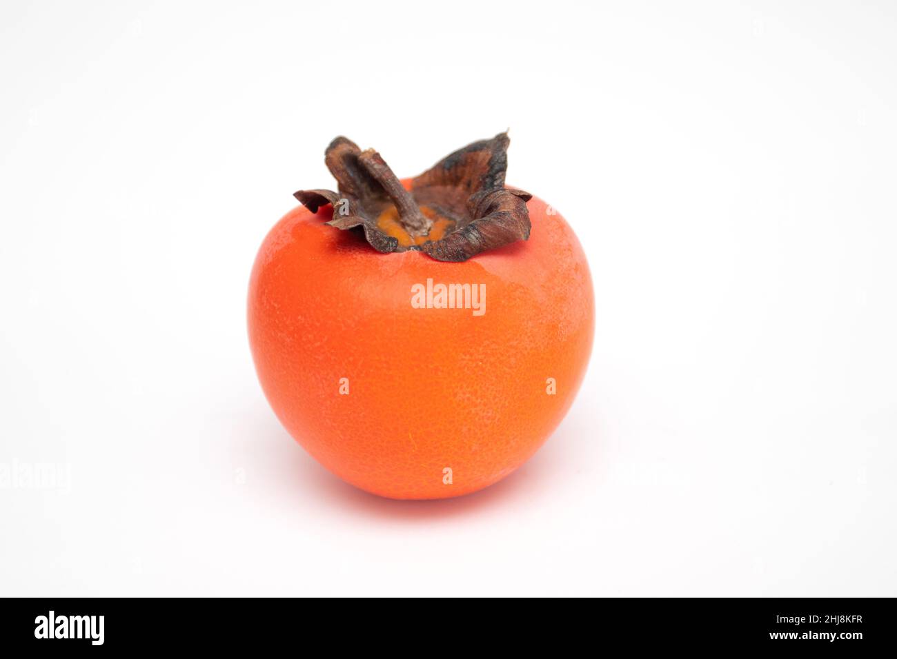 Whole ripe persimmon on a white background Stock Photo - Alamy