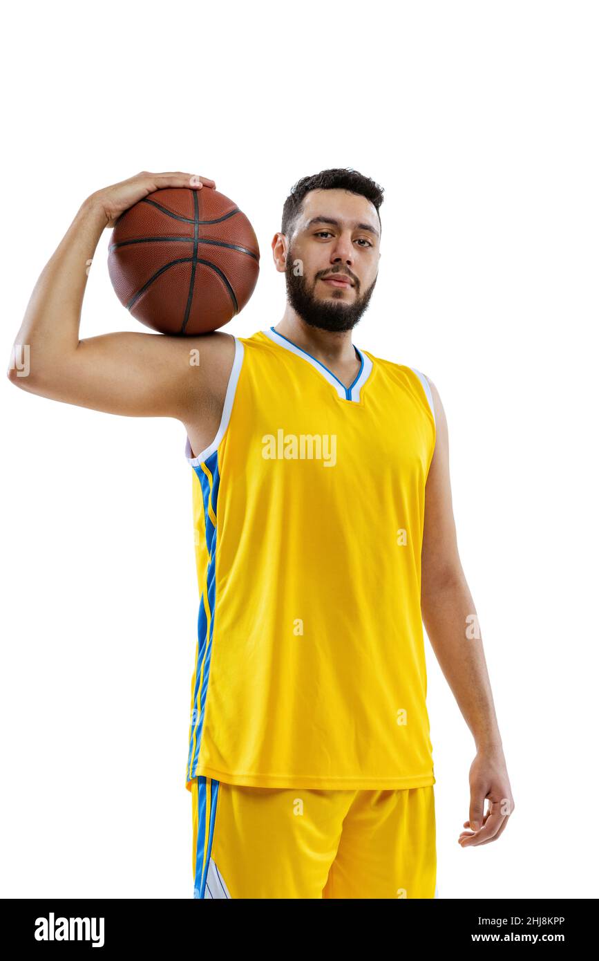 Portrait of young man, professional basketball player standing with ...