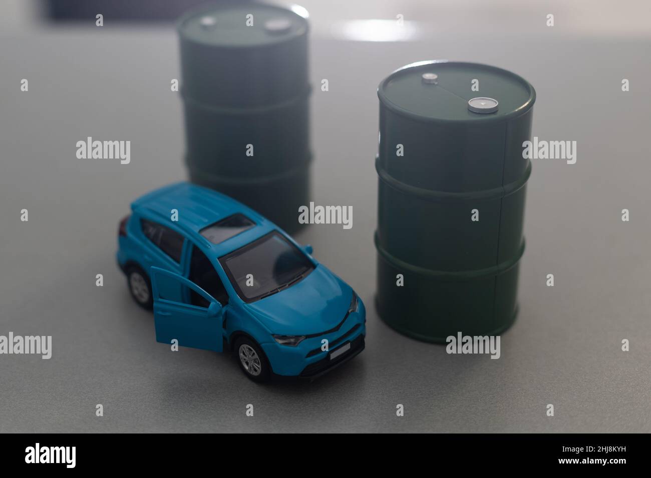 Toy car with toy oil barrel on white background Stock Photo - Alamy