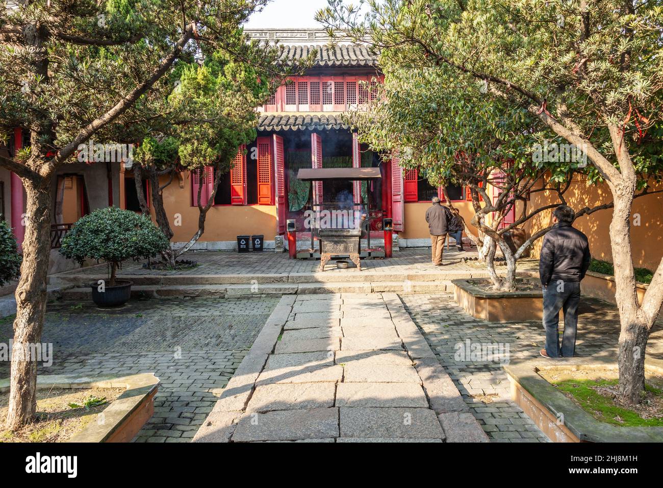 Inner courtyard of a Buddhist temple with its incense-burning altar ...
