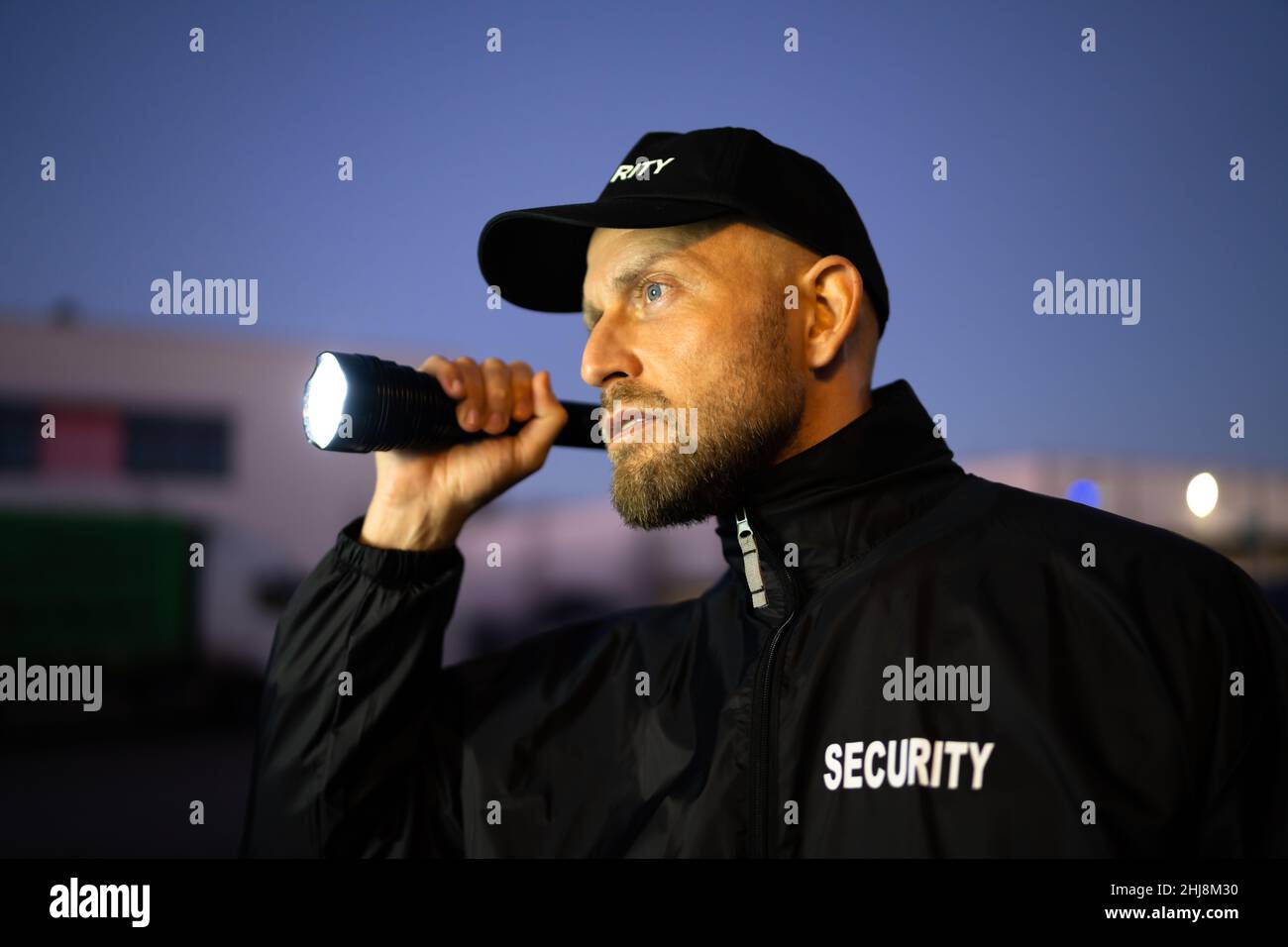 Security Guard Walking Outdoors With Flashlight At Night Stock Photo ...