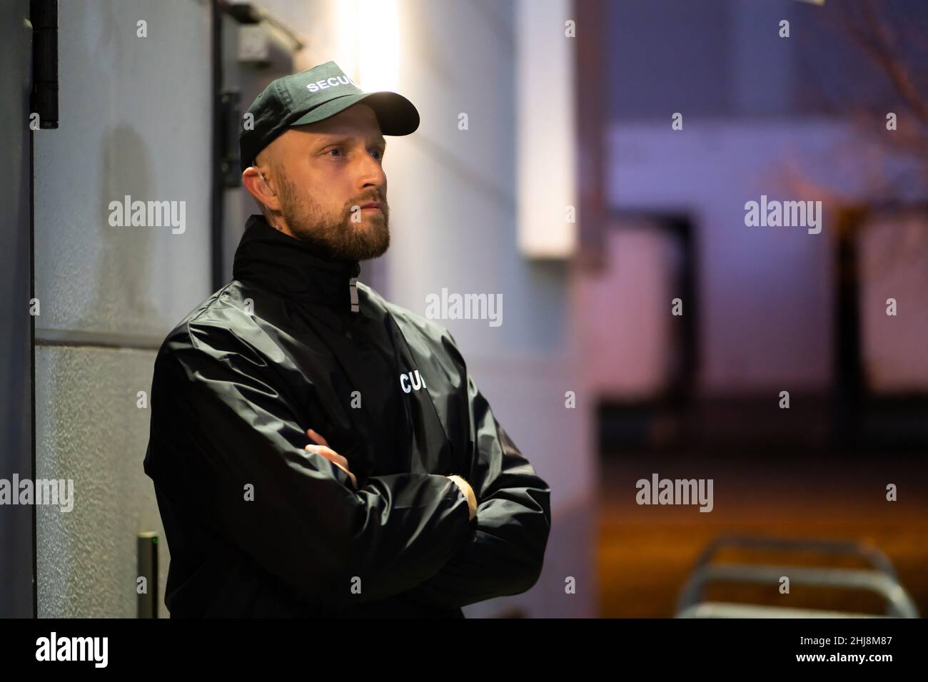 Security Guard Standing In Front Of Building At Night Stock Photo - Alamy