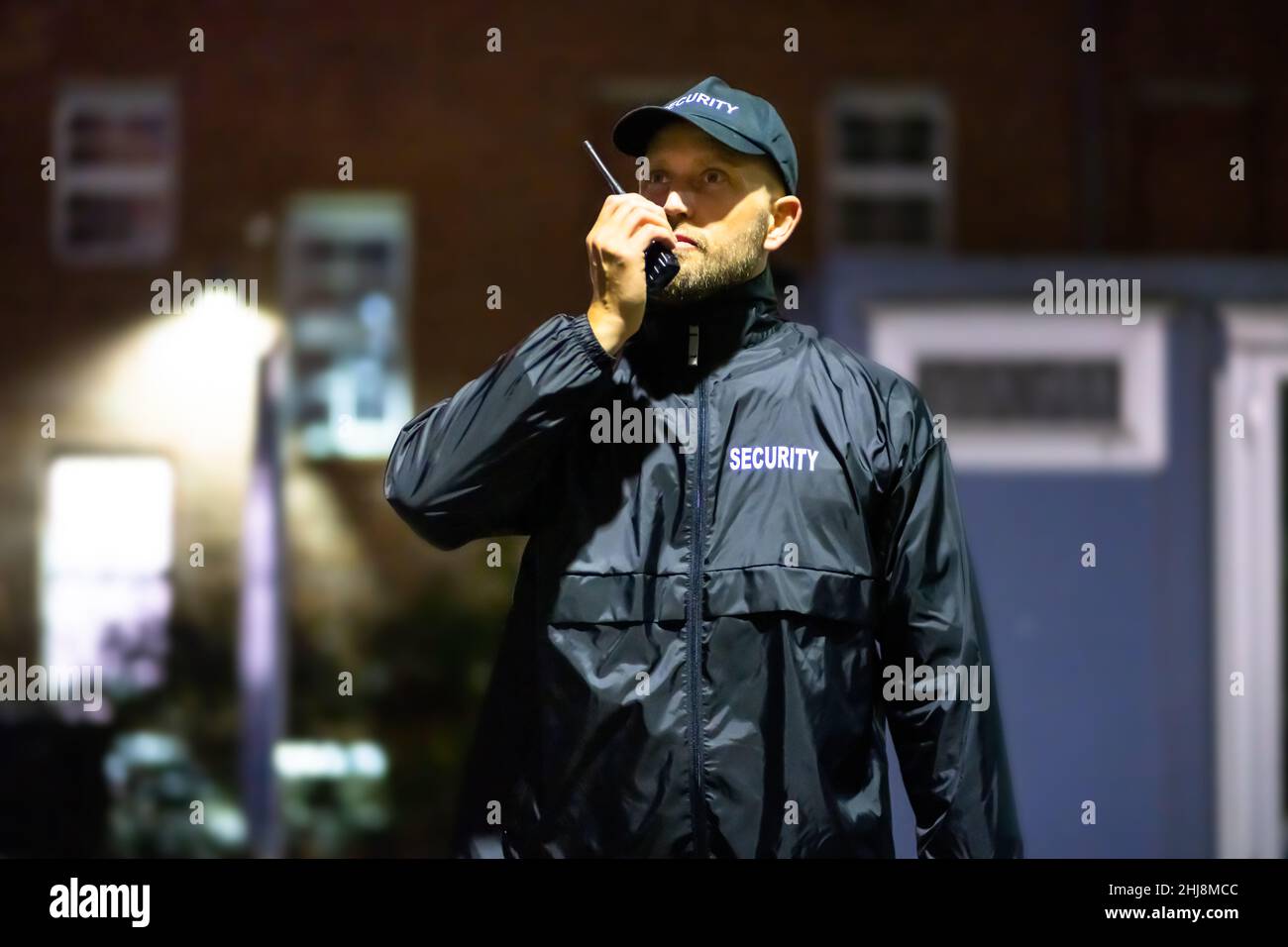 Security Guard At Entrance Gate At Night Stock Photo - Alamy
