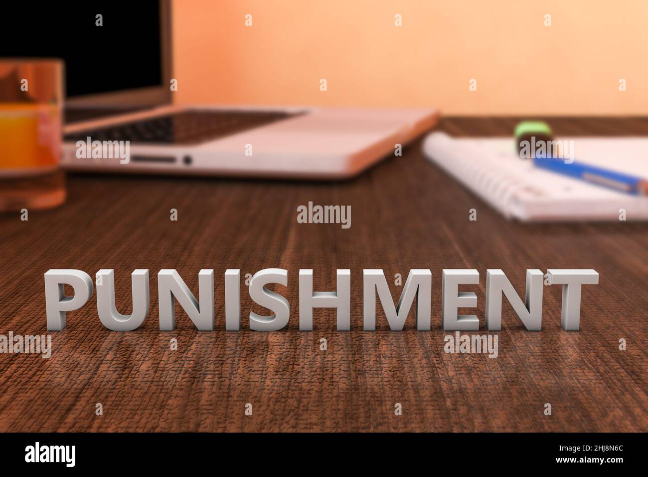 Punishment - letters on wooden desk with laptop computer and a notebook ...