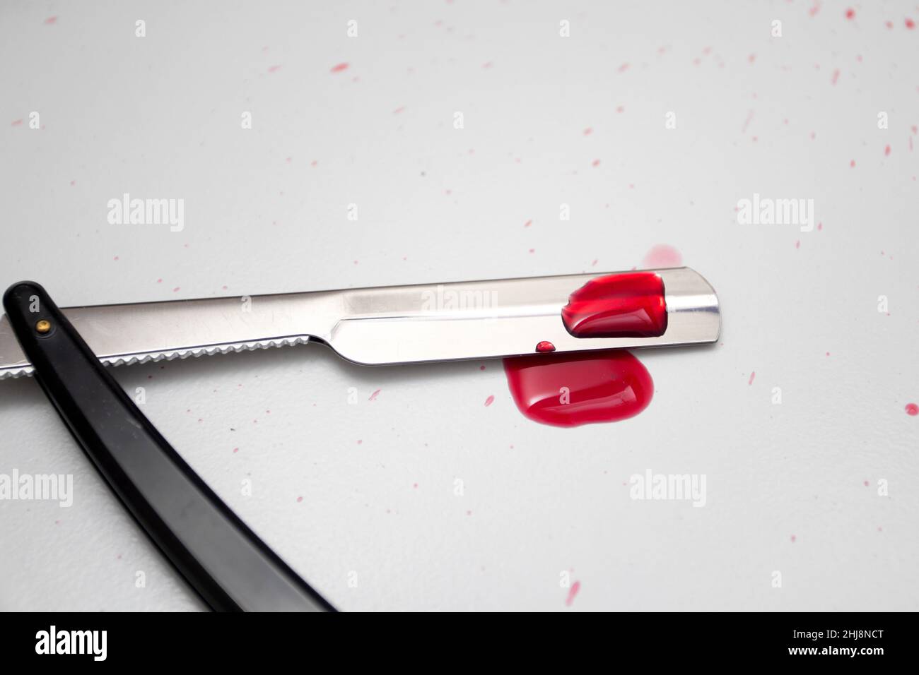 Drops of blood on a straight razor Stock Photo - Alamy