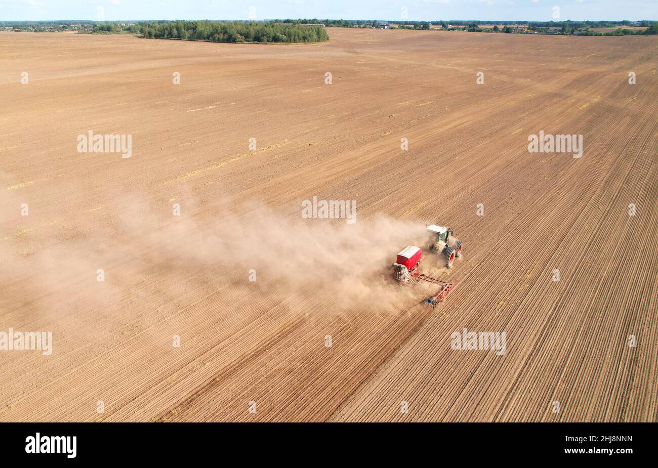 Tractor sowing seed onto at field. Planting Equipment and Farm ...