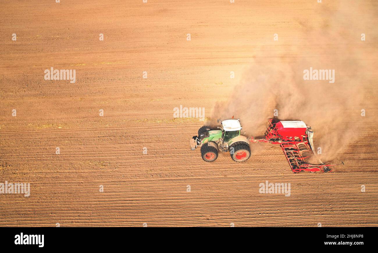 Tractor sowing seed onto at field. Planting Equipment and Farm ...