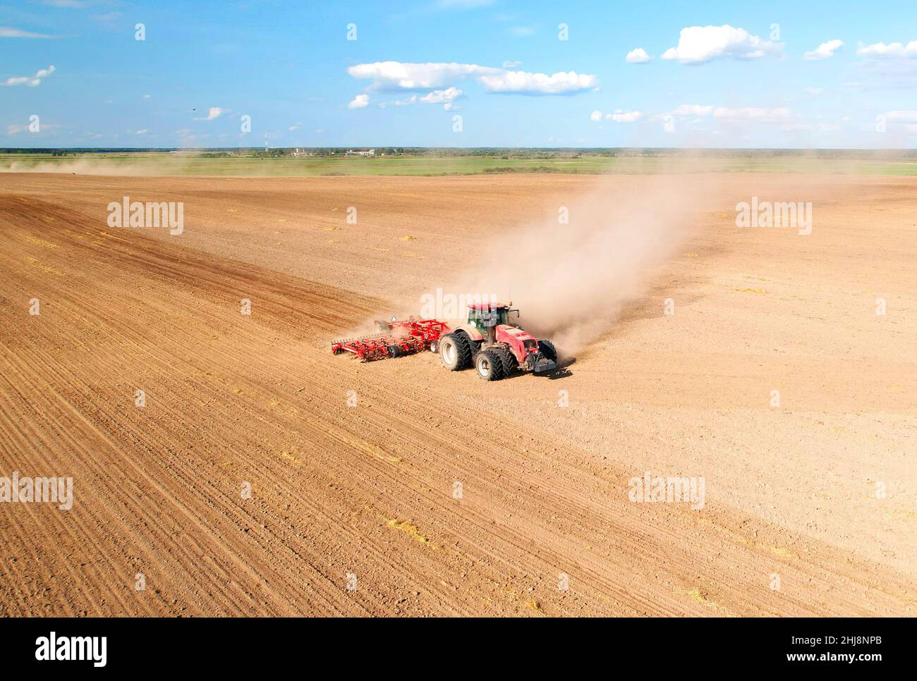 Tractor during field plowed, aerial view. Ploughing and soil Tillage. Agricultural Tractor with ...