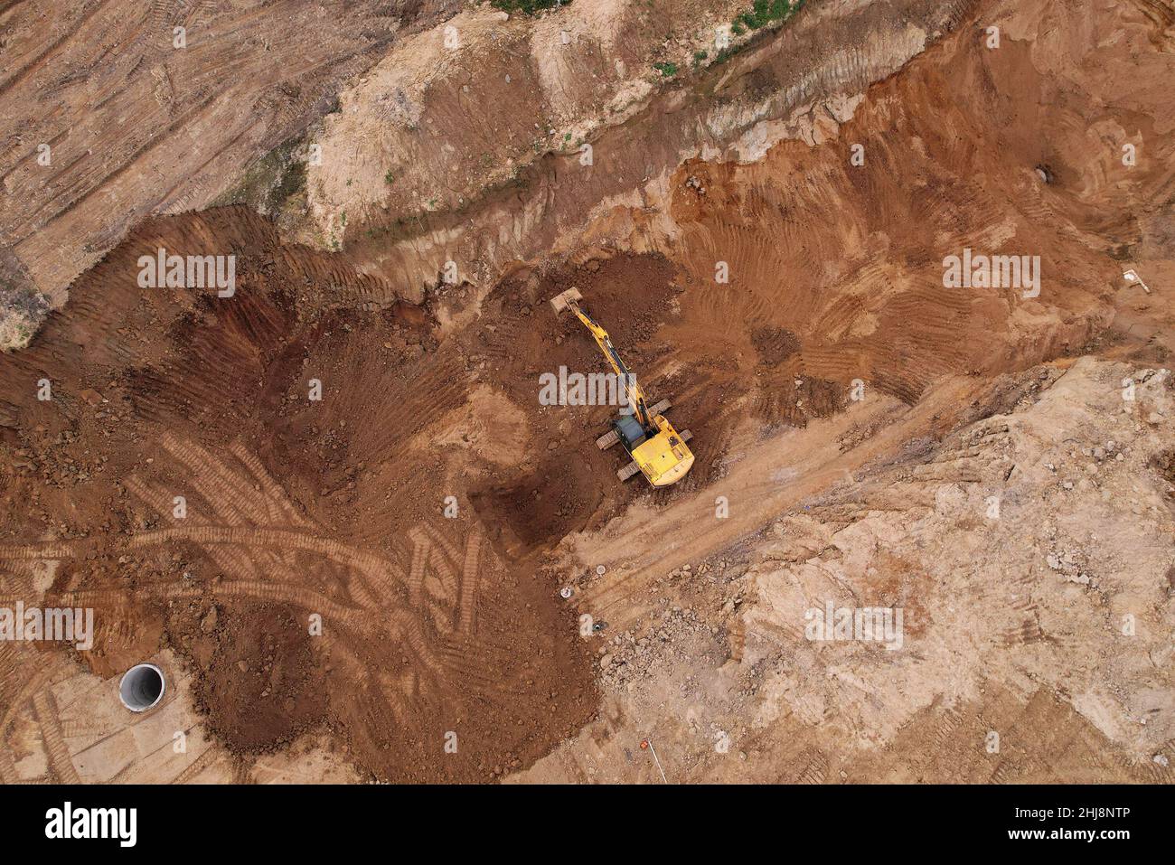 Excavator dig ground for sewerge construction. Trench for laying a ...