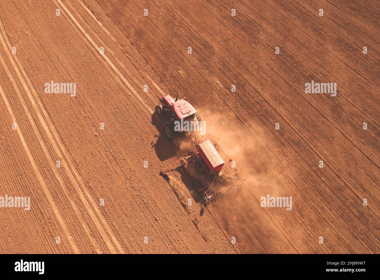 Tractor sowing seed onto at field. Planting Equipment and Farm ...
