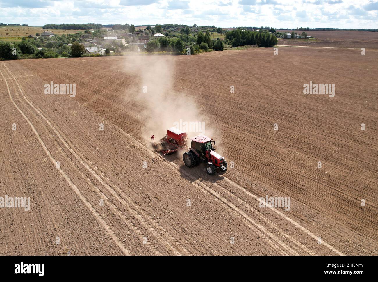 Tractor sowing seed onto at field. Planting Equipment and Farm ...