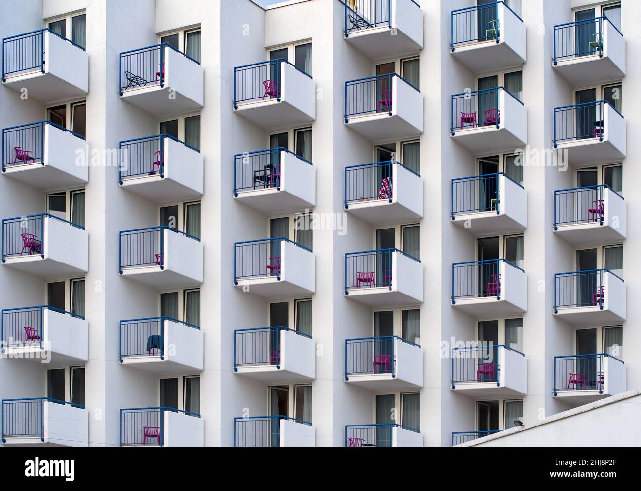 White abstract background of a modern apartment building with balconies ...