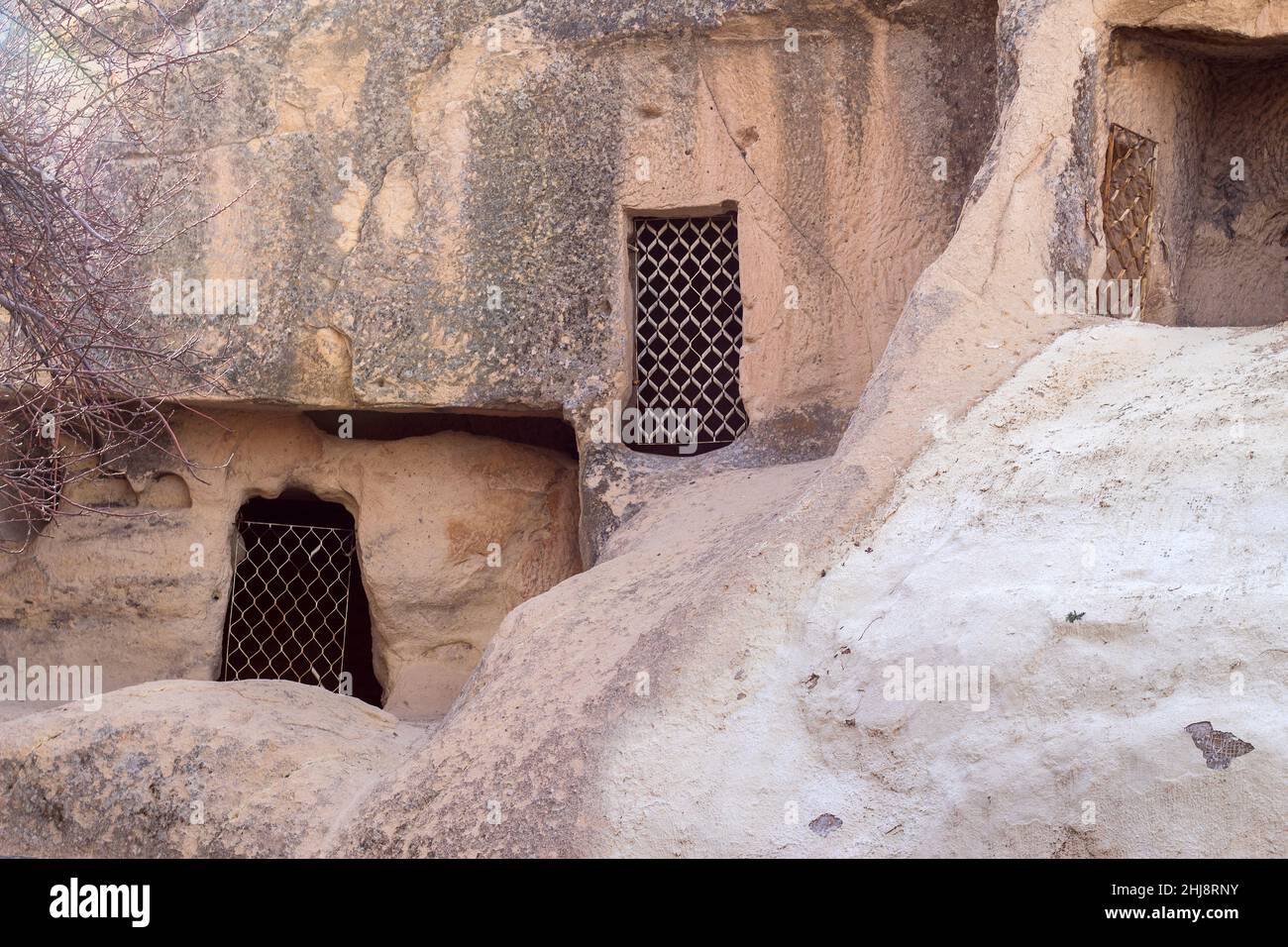 Cave houses and buildings in Cappadocia, Turkey. Stone peaks with doors ...