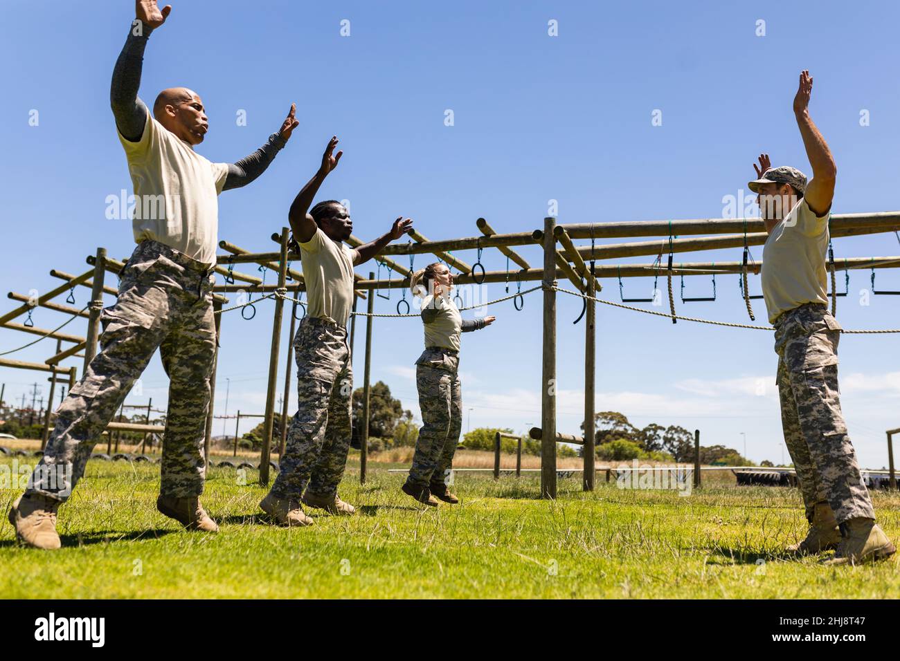 Group of male and female diverse soldiers performing jumping jacks ...