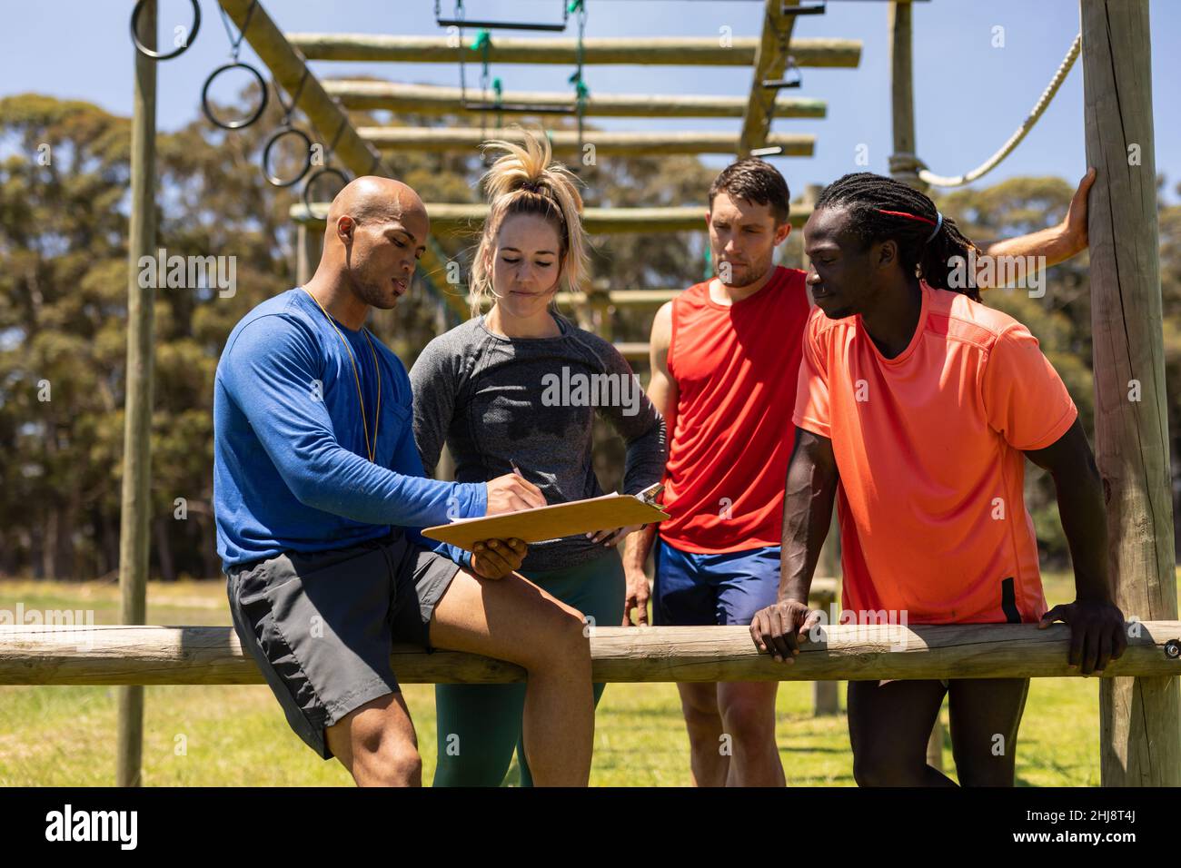 African american male instructor instructing group of male and female ...