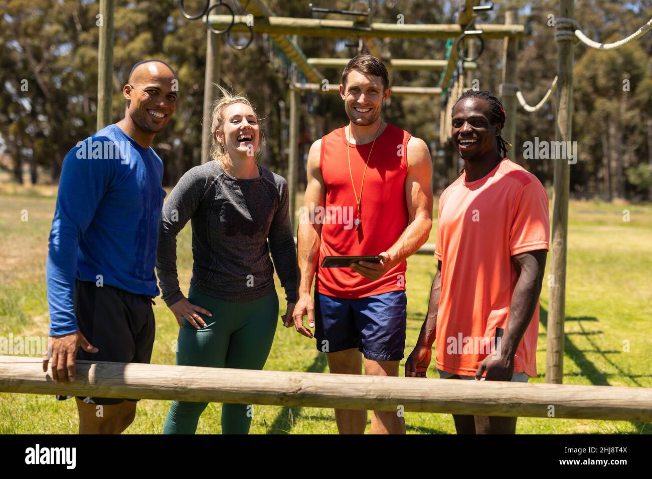 Portrait of male caucasian instructor and group of male and female fit ...