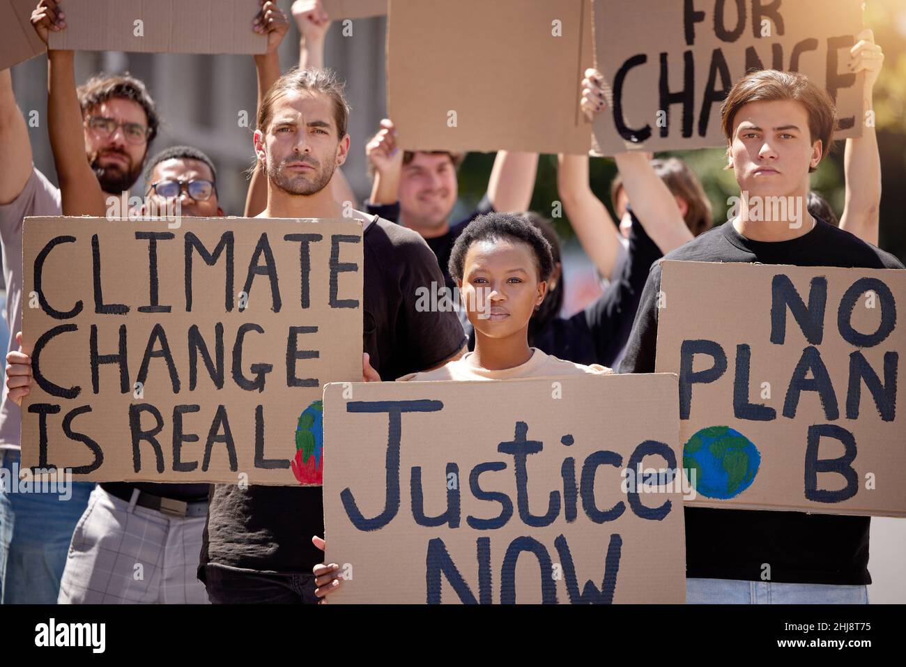 We only have one planet. Shot of a group of people protesting climate ...