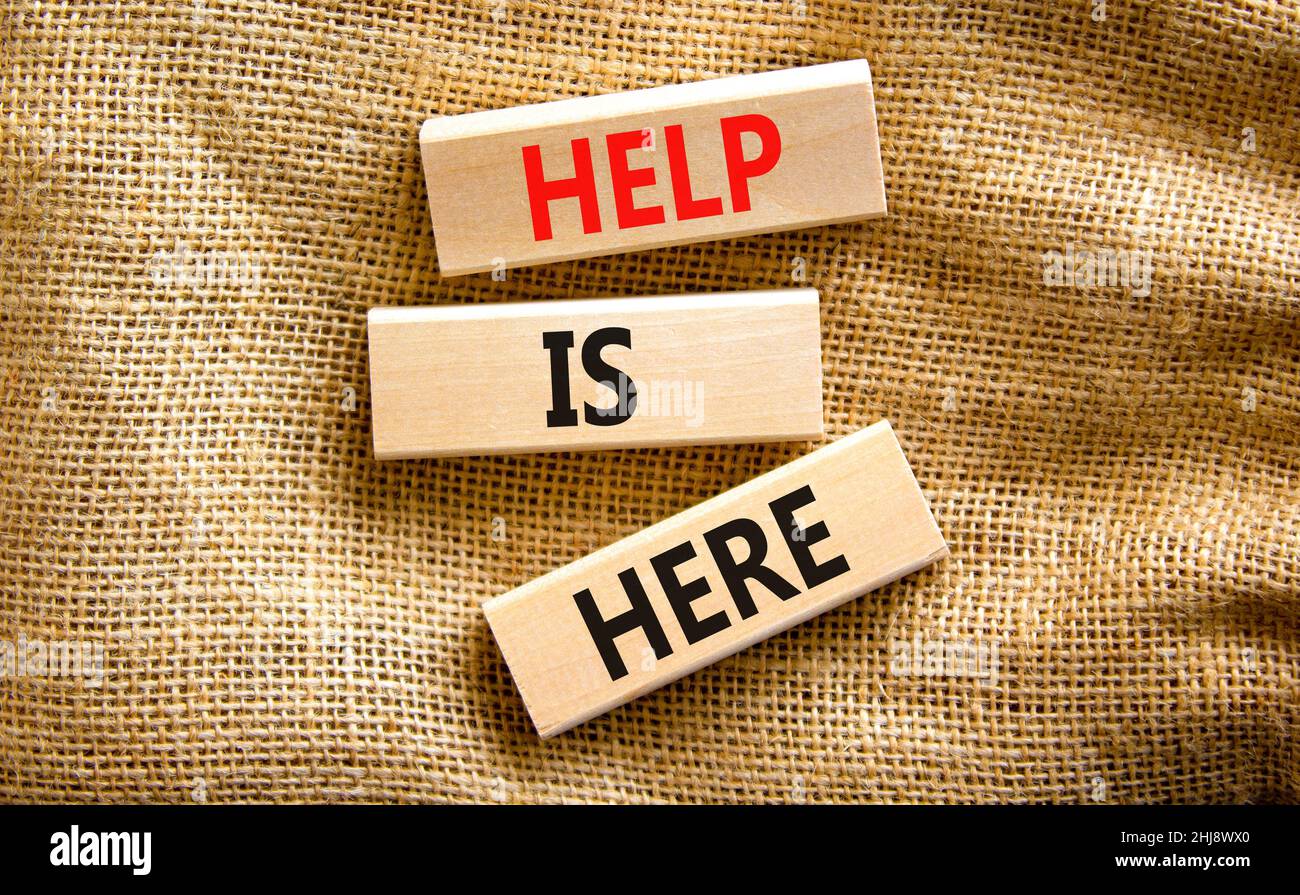 Help is here and support symbol. Concept words Help is here on wooden ...