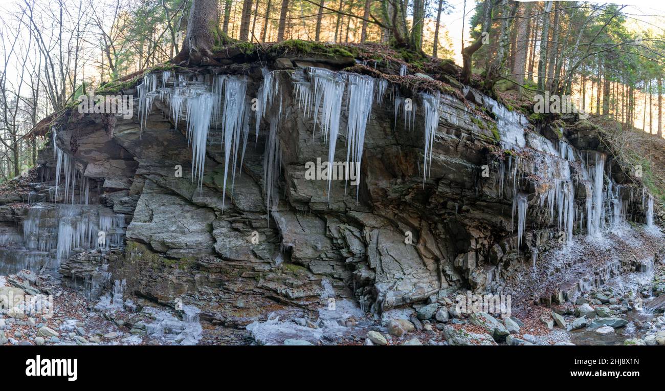 Ice sticks hanging on the rock Stock Photo - Alamy