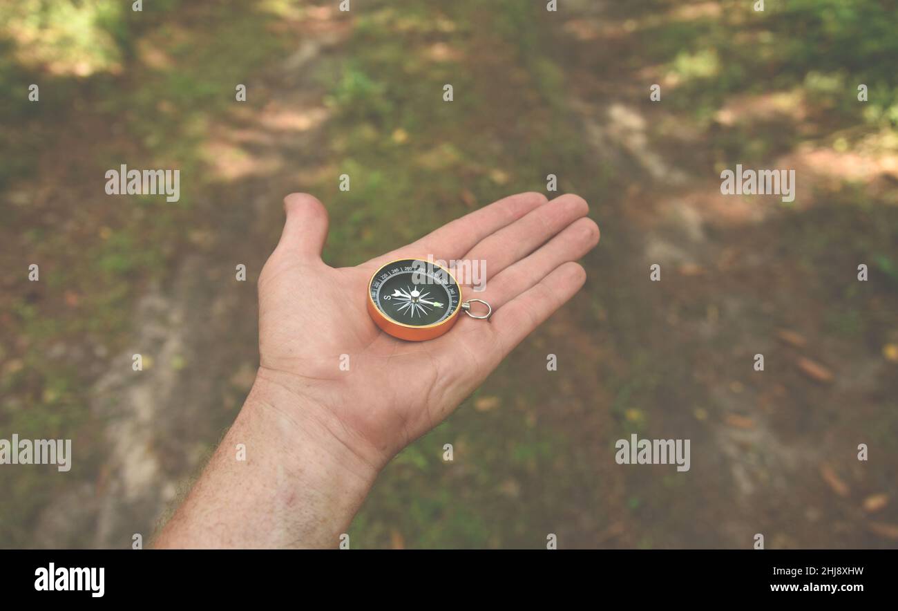 Compass in hand at forest. Tourist compass for orientation on the ...
