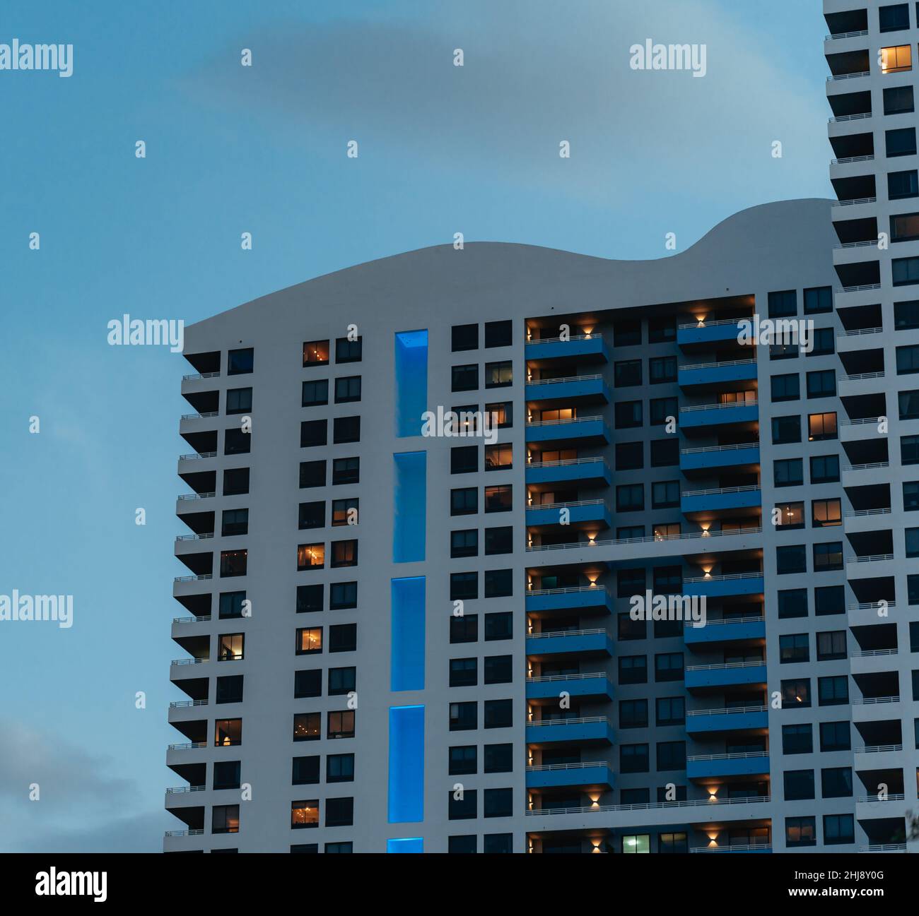 Modern skyscraper on blue sky background in the evening Stock Photo - Alamy