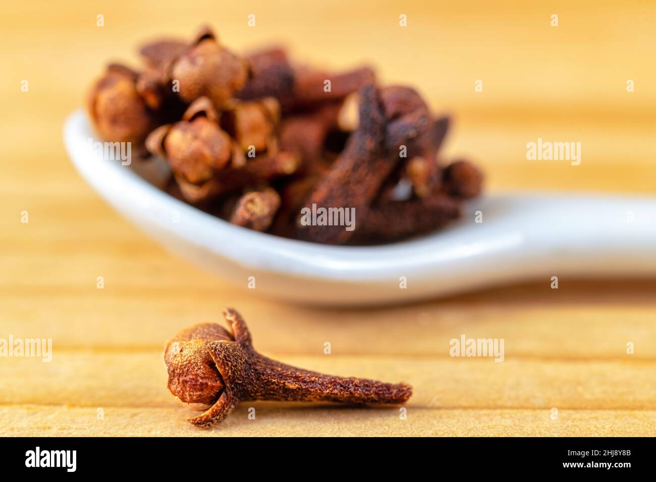 Macro of clove spice in wood background Stock Photo - Alamy