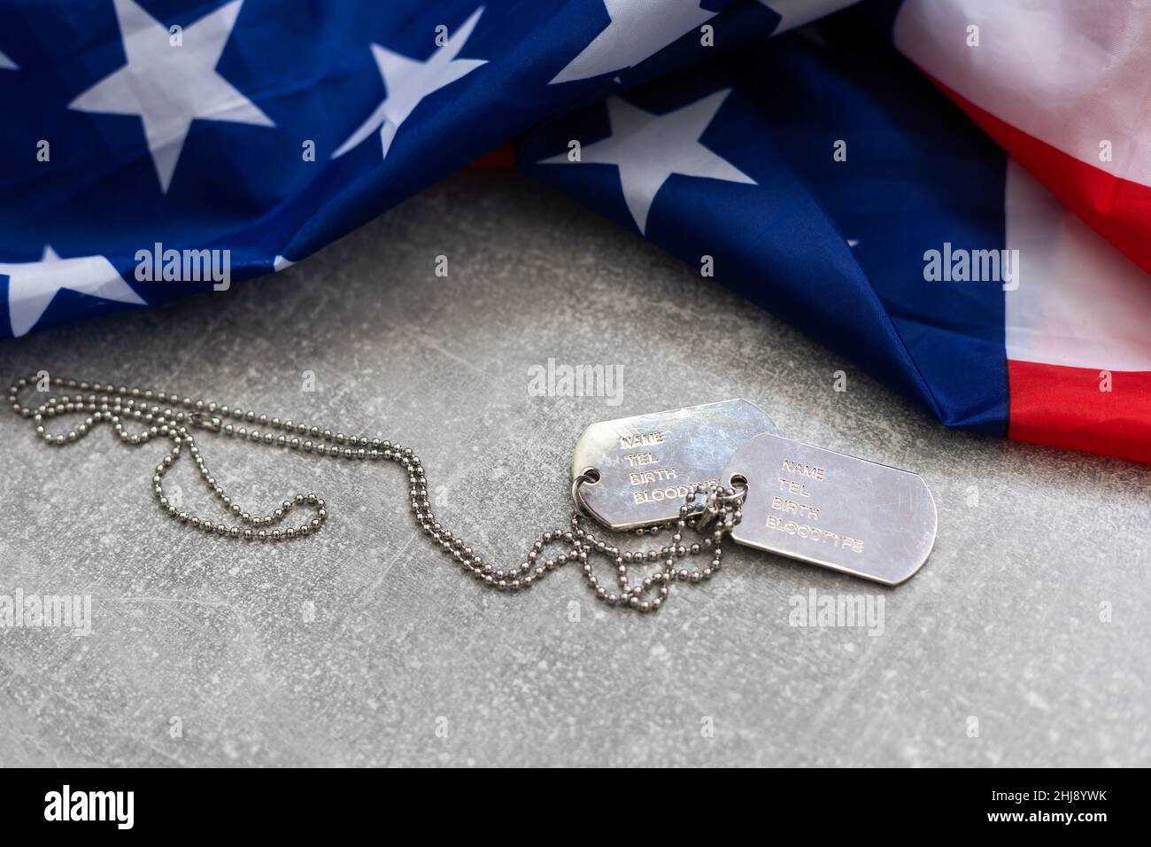 Authentic military dog tag on an american flag Stock Photo - Alamy
