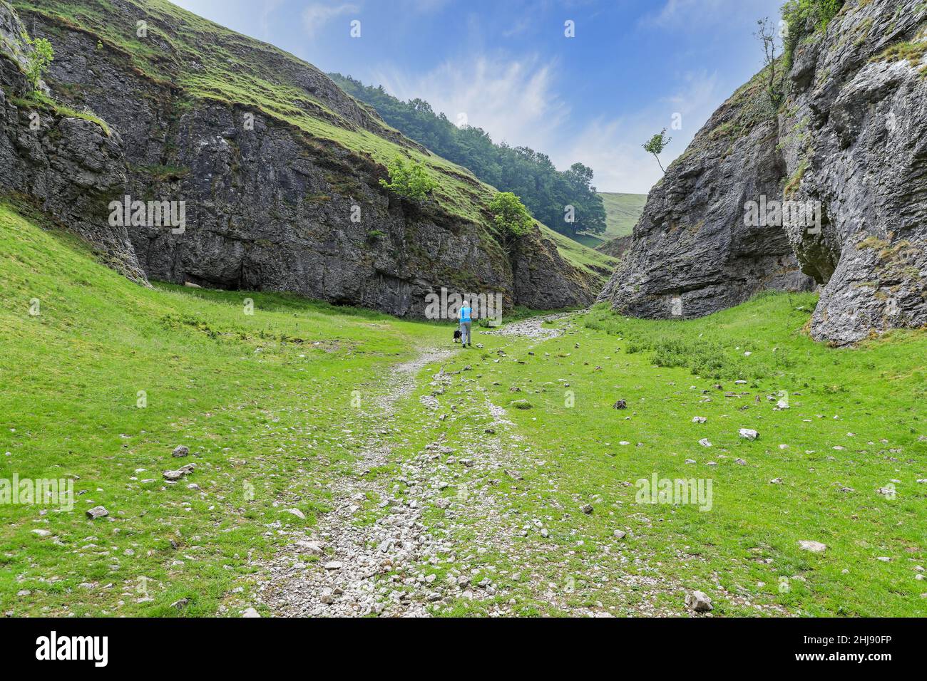 A woman walking in Cave Dale (or Cavedale), a dry limestone valley in ...