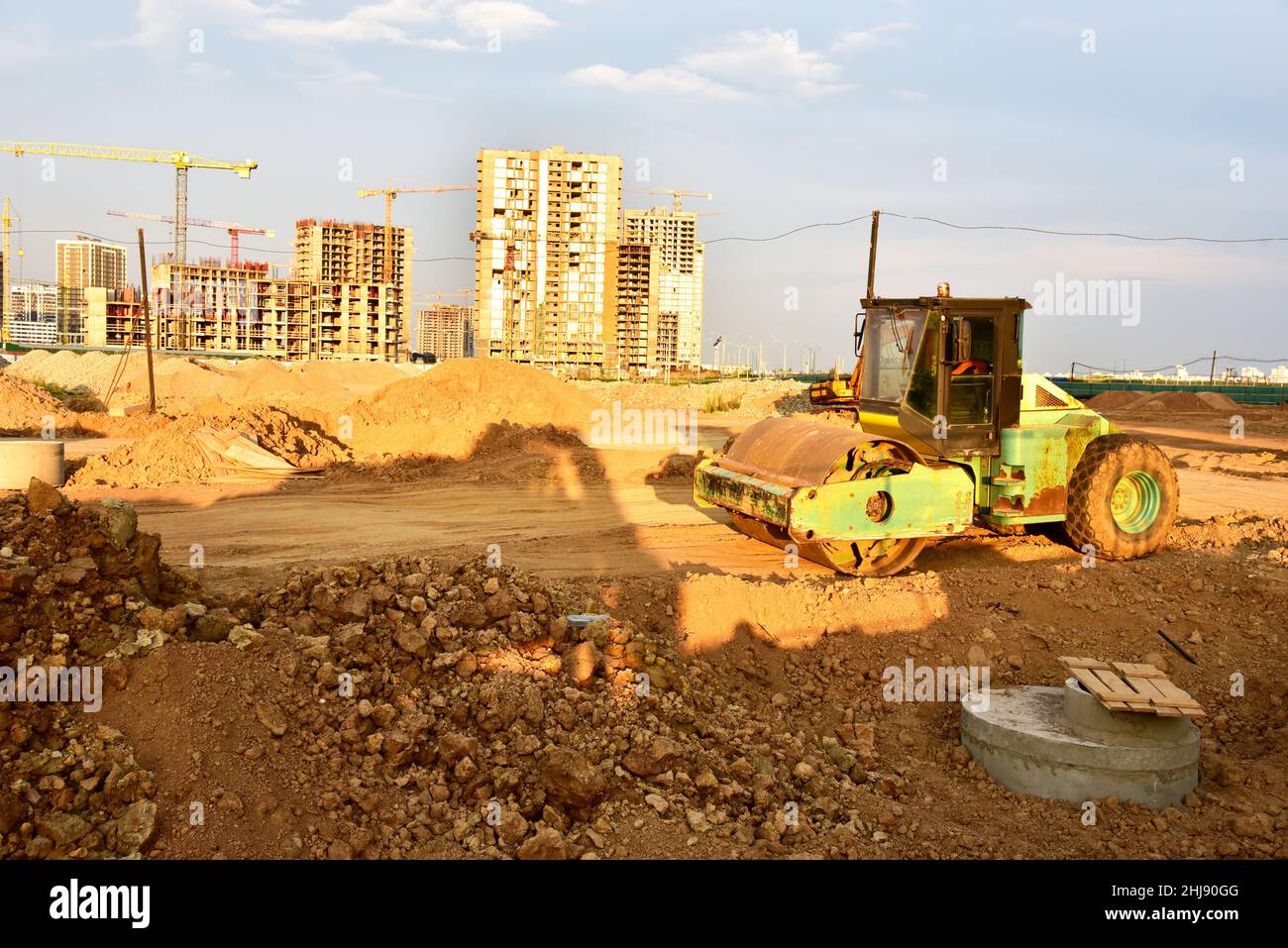 Soil Compactor leveling ground at construction site. Vibration single ...
