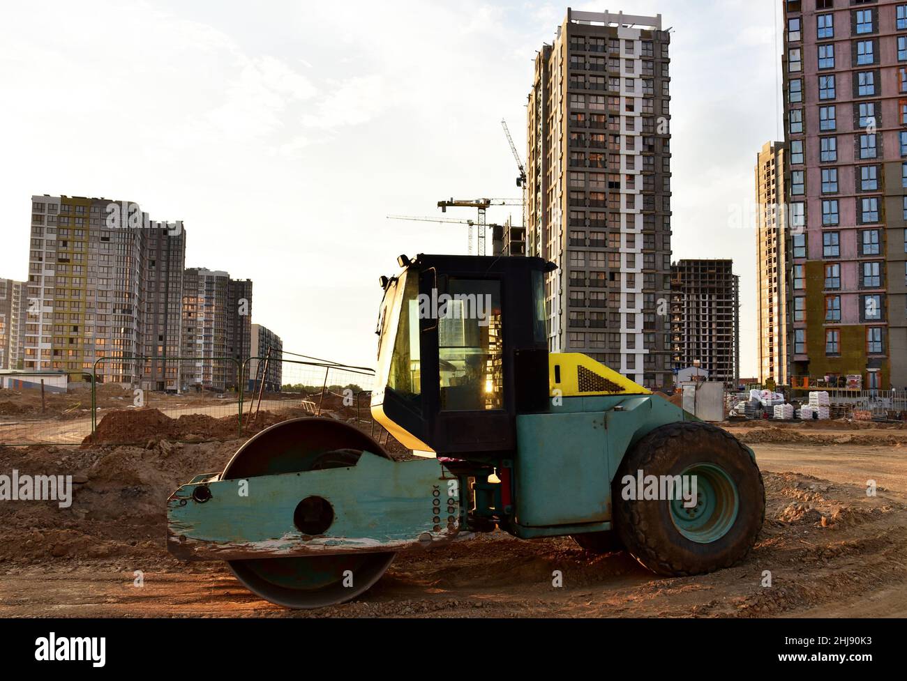 Soil Compactor leveling ground at construction site. Vibration single ...