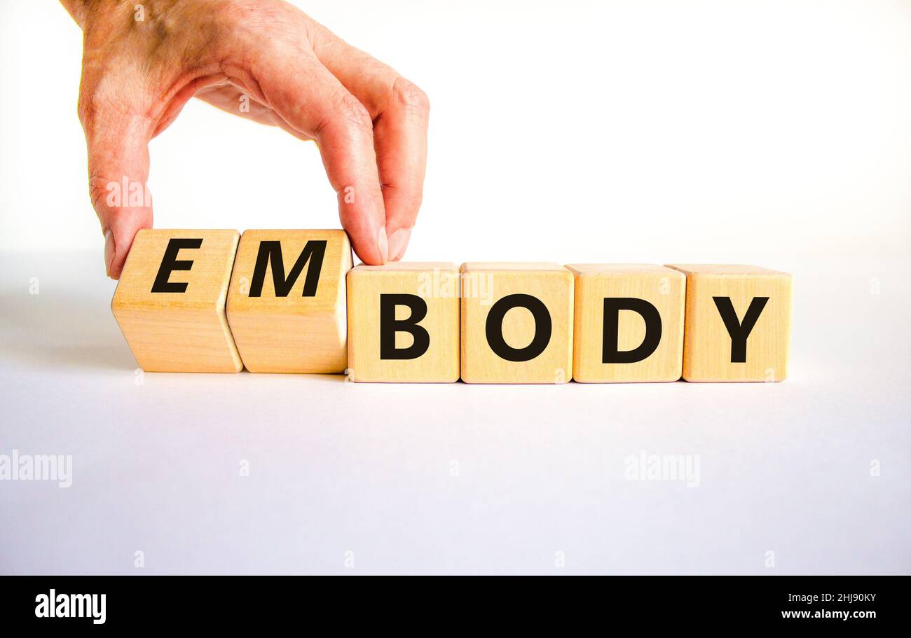 Body and embody symbol. Doctor turns wooden cubes and changes the ...